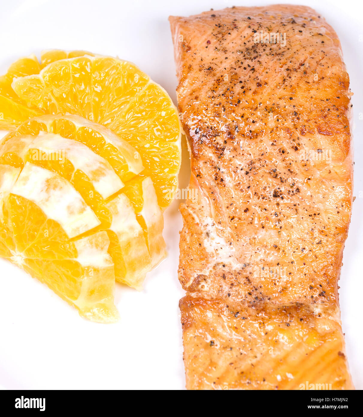 grilled red fish with orange on white background Stock Photo - Alamy