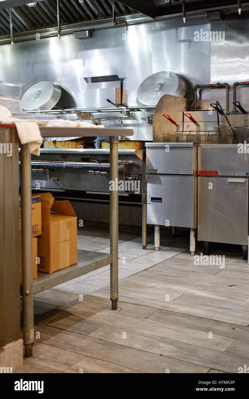 View into the stainless steel kitchen of a well-worn restaurant in ...