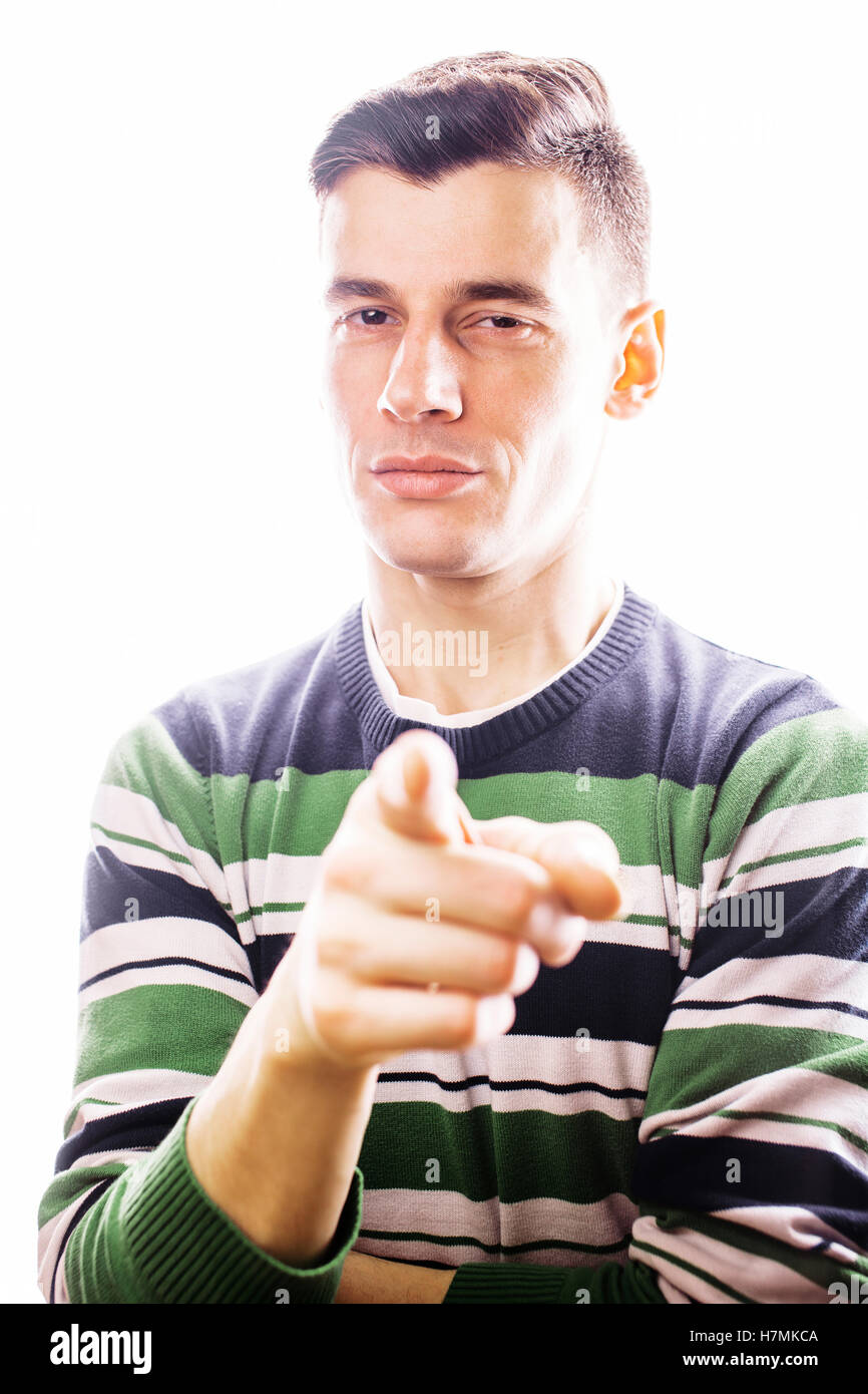 Portrait of a smart serious young man standing against white bac Stock ...