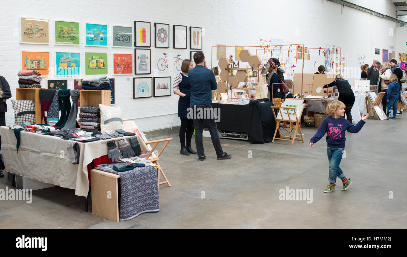Young boy walking around designer stalls at the Renegade Craft Fair, an ...