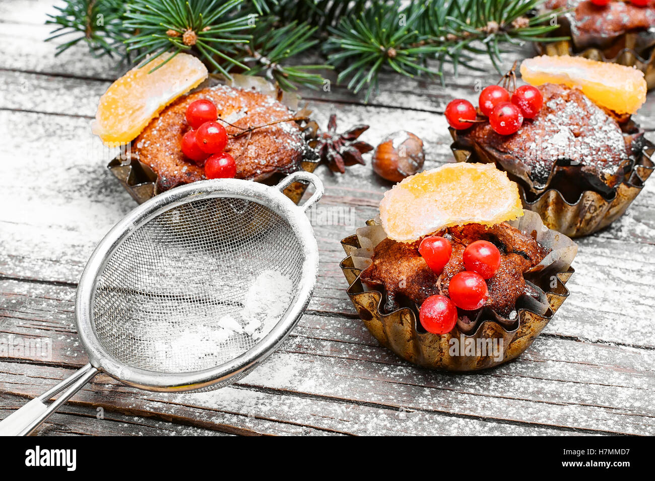 Chocolate Christmas muffins,sieve the powder on background with branch ...