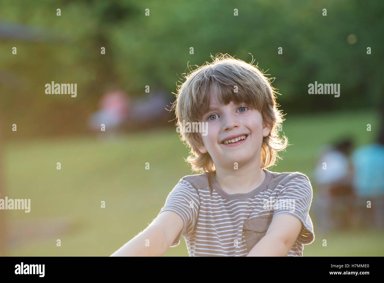 Portrait of a blonde boy with blurred background Stock Photo - Alamy