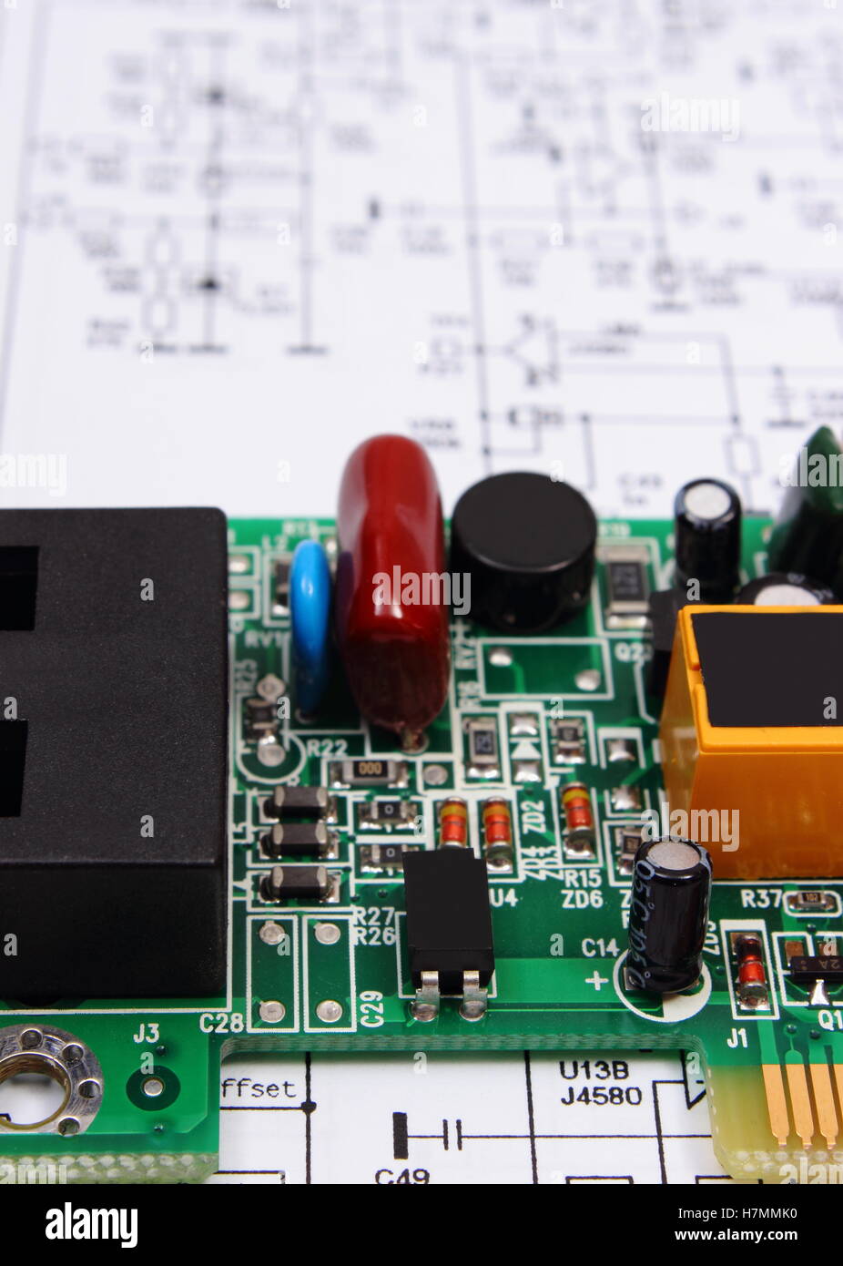 Printed circuit board with electrical components lying on construction ...