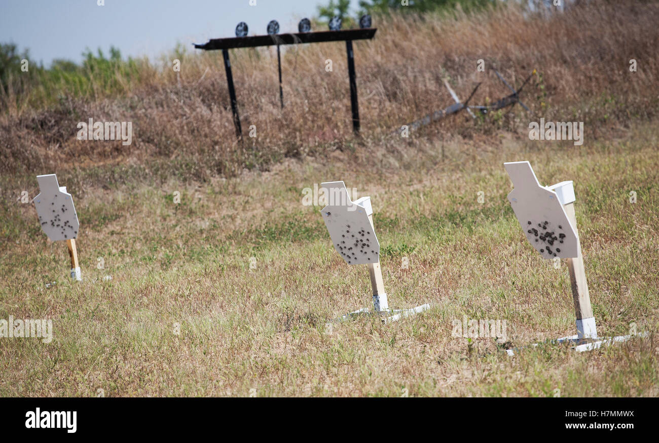 Three white still targets with pie plates behind down range Stock Photo ...