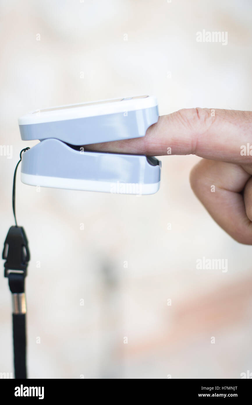 Portable hand held domestic cardiac finger pulse rate meter to show ...