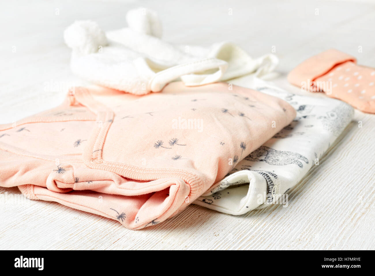 Set of pink baby clothes on wooden background, close up Stock Photo - Alamy