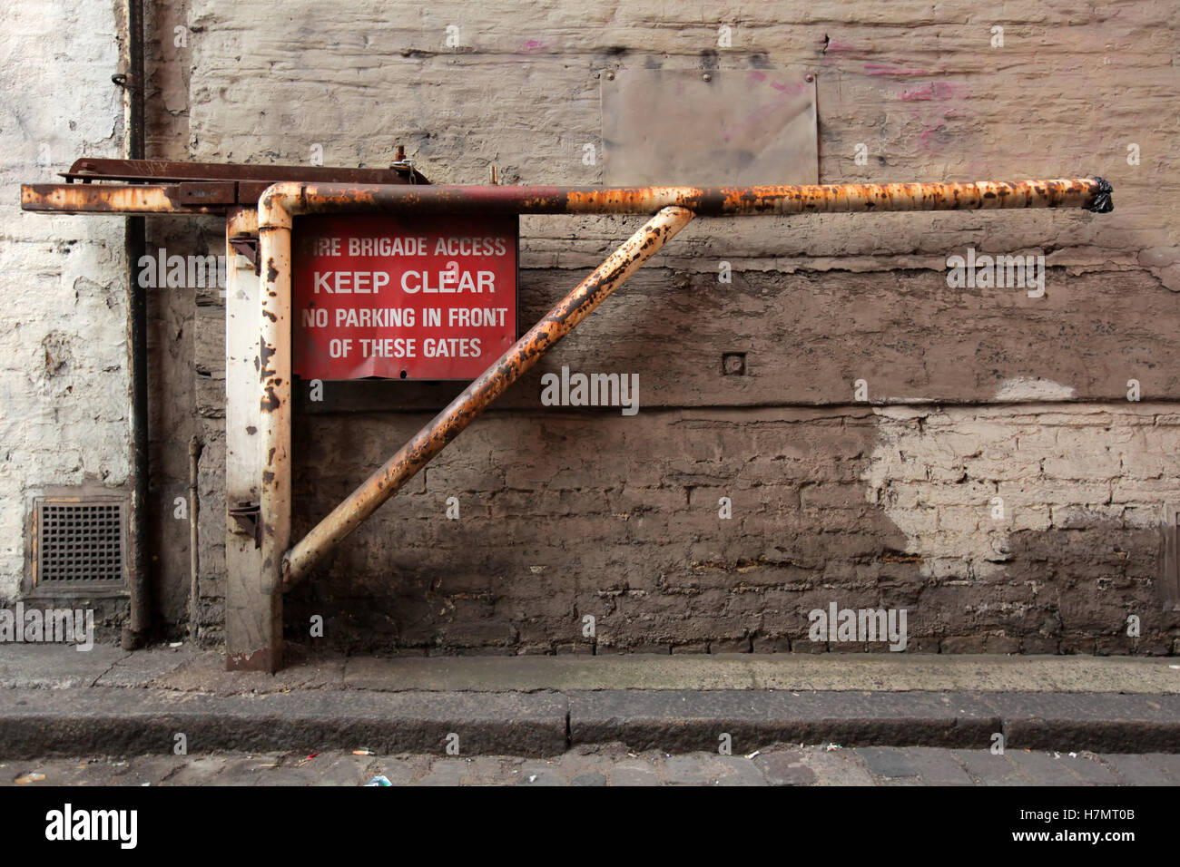 Old rusted barrier with a KEEP CLEAR sign and information that this ...