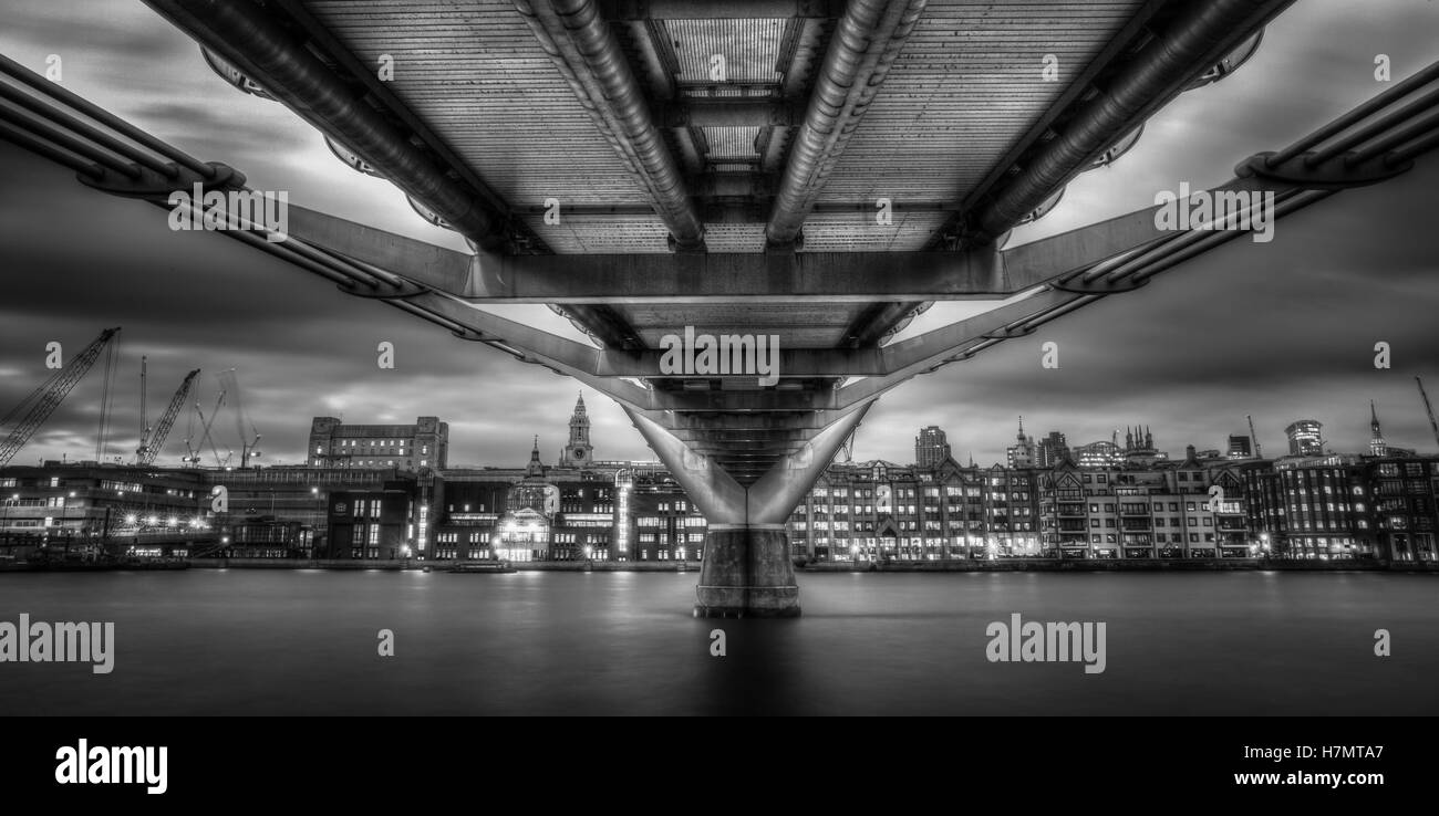 Look from below the London Millennium Footbridge across Thames river ...