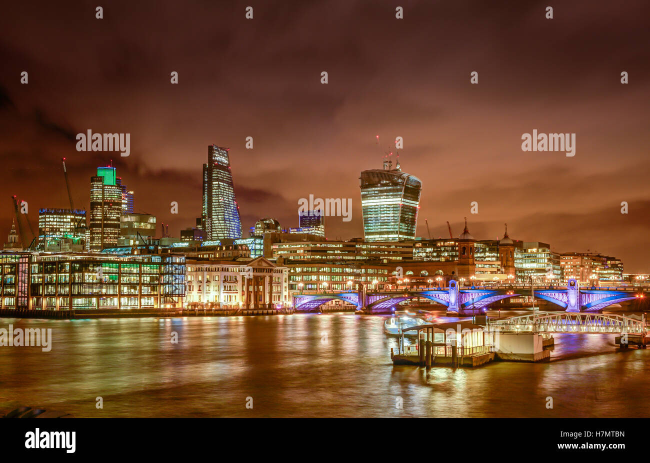 Night skyline of London as seen from the Thames riverbank, England ...