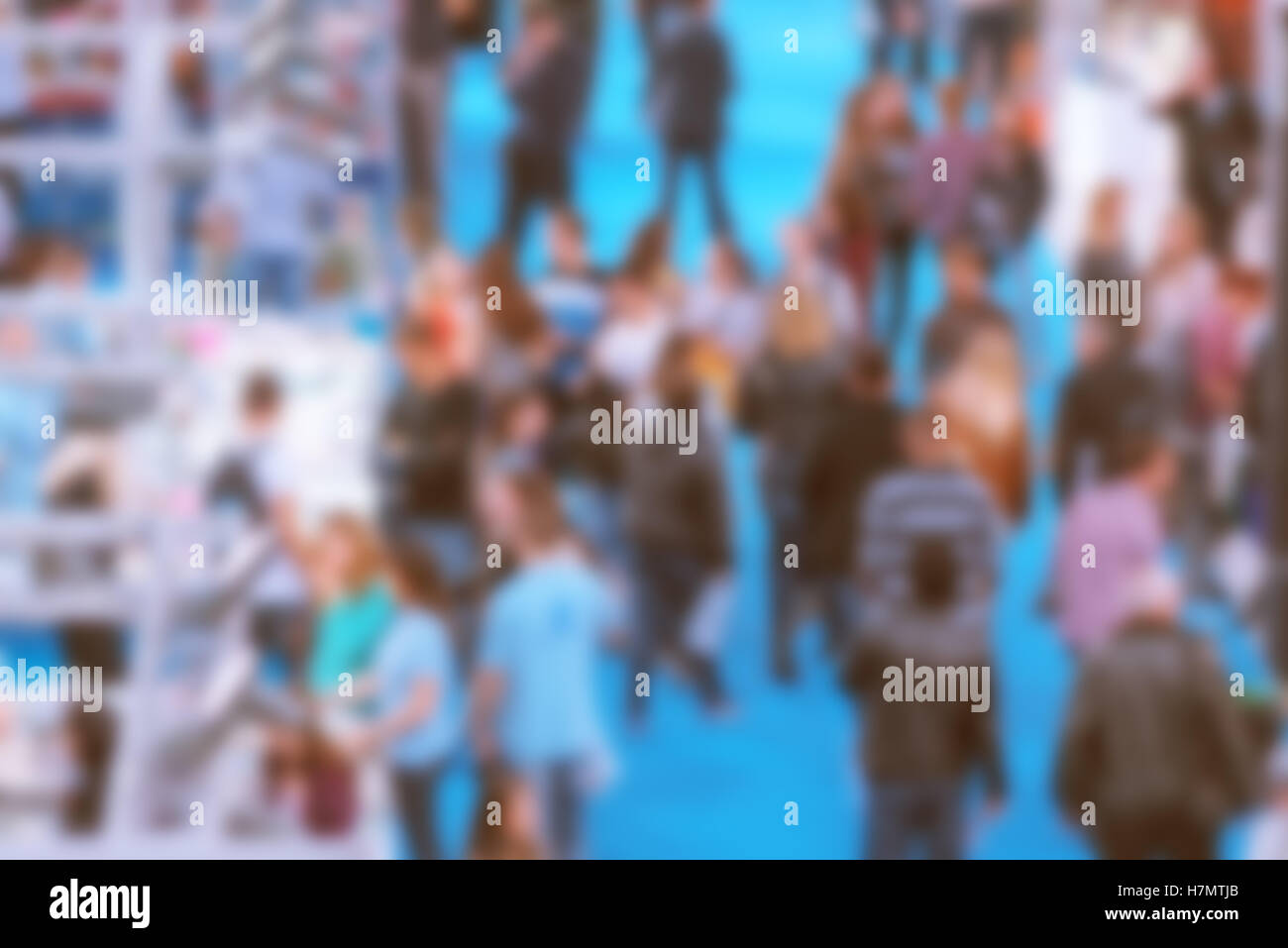 Abstract blurred people attending event in exhibition hall, press ...