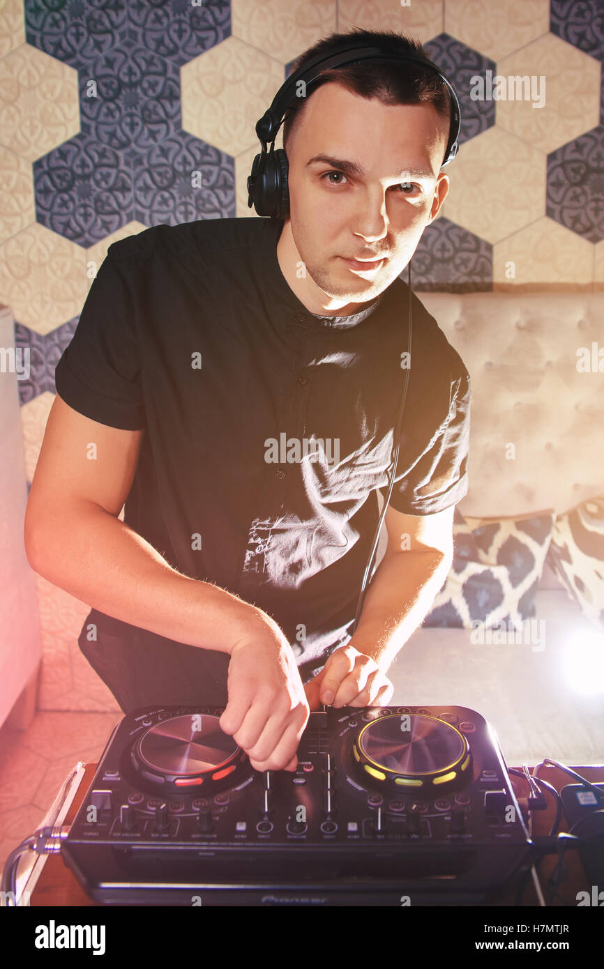 Young man DJ with mixer is working Stock Photo - Alamy