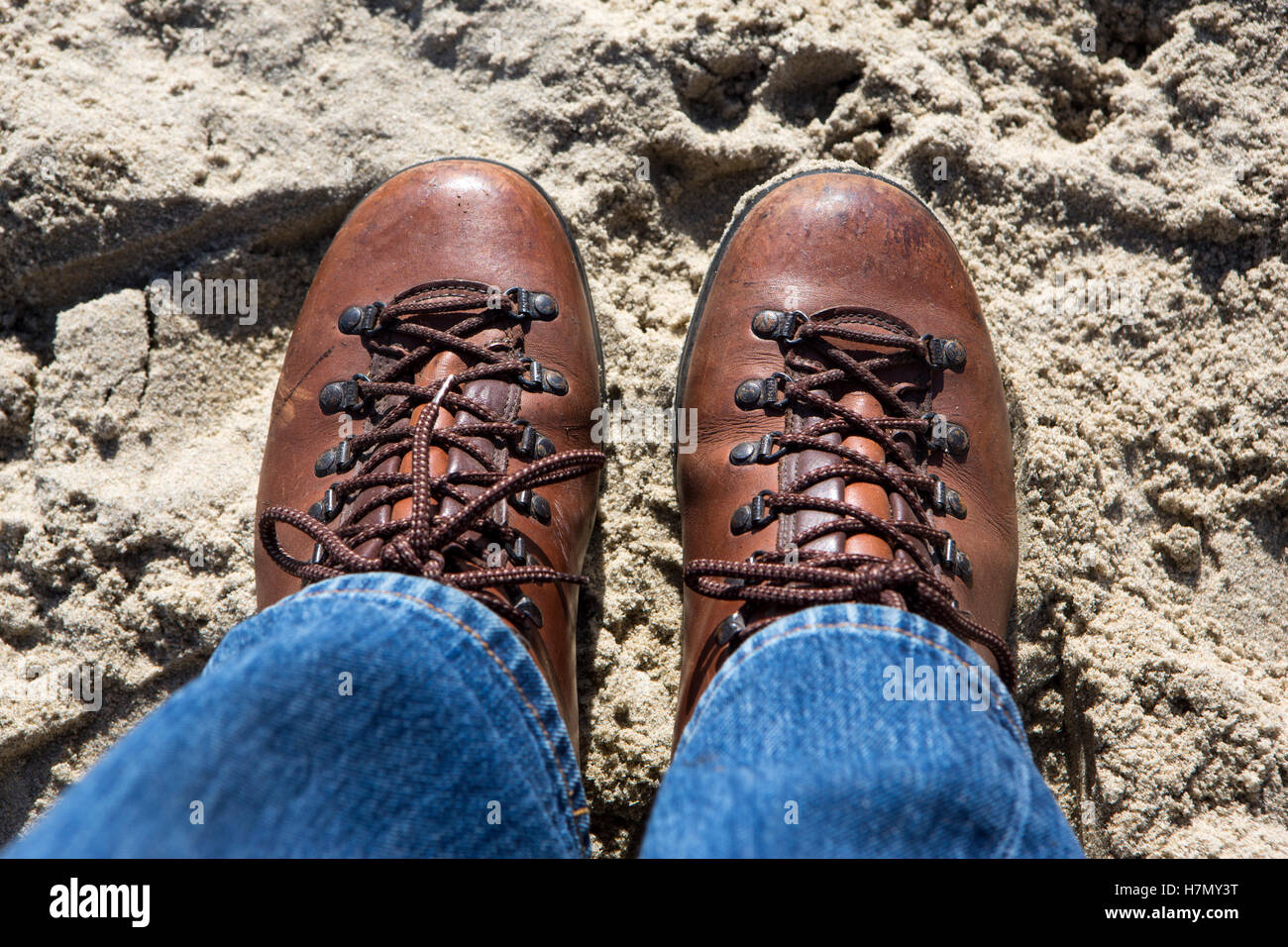 Walking boots on sand Stock Photo - Alamy