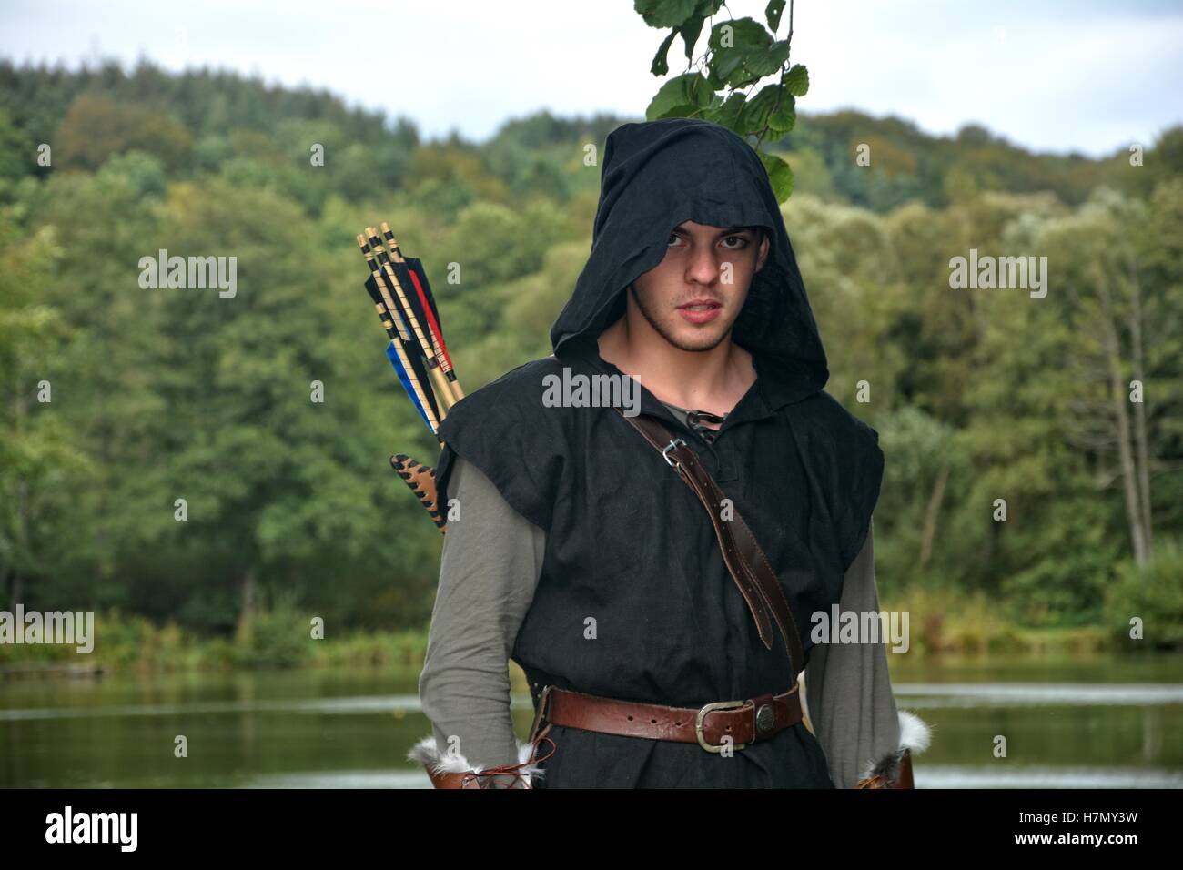 Medieval archer with black hood and coloured arrows in the quiver ...