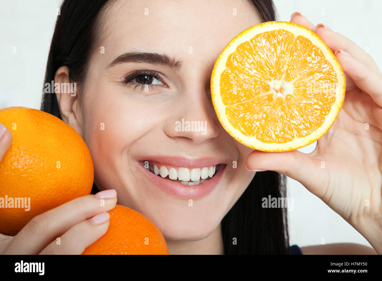 Woman with orange close-up face. Beautiful women exists to clean skin ...