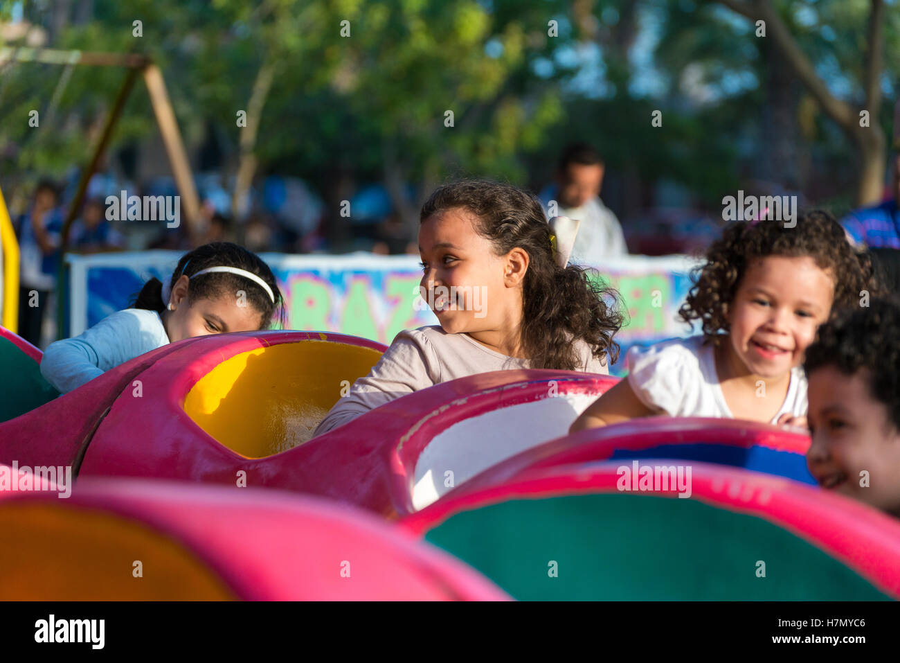Happy Young Kids Having Fun at Amusement Park Stock Photo - Alamy