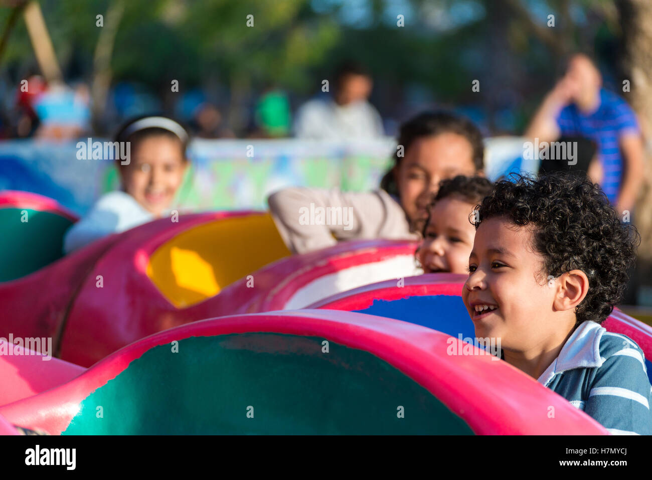 Happy Young Children Having Fun at Amusement Park Stock Photo - Alamy