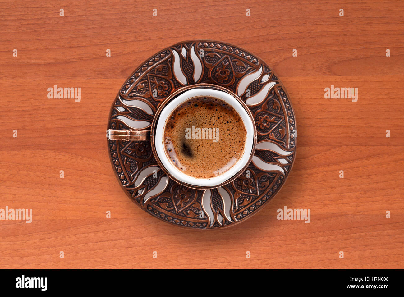 Top view of traditional cup of Turkish coffee with foam on wooden table ...