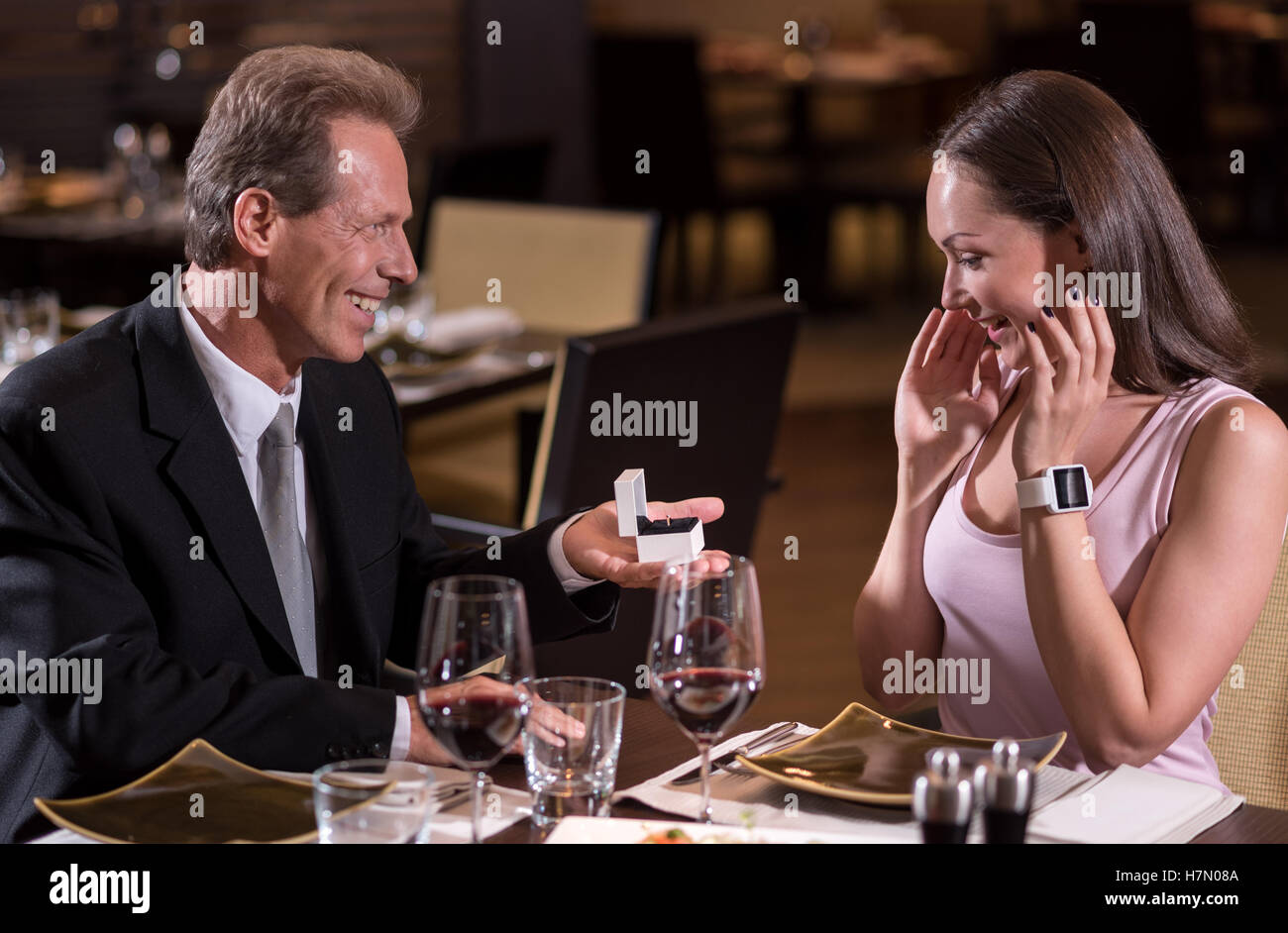 Smiling positive man giving a ring to the woman Stock Photo - Alamy