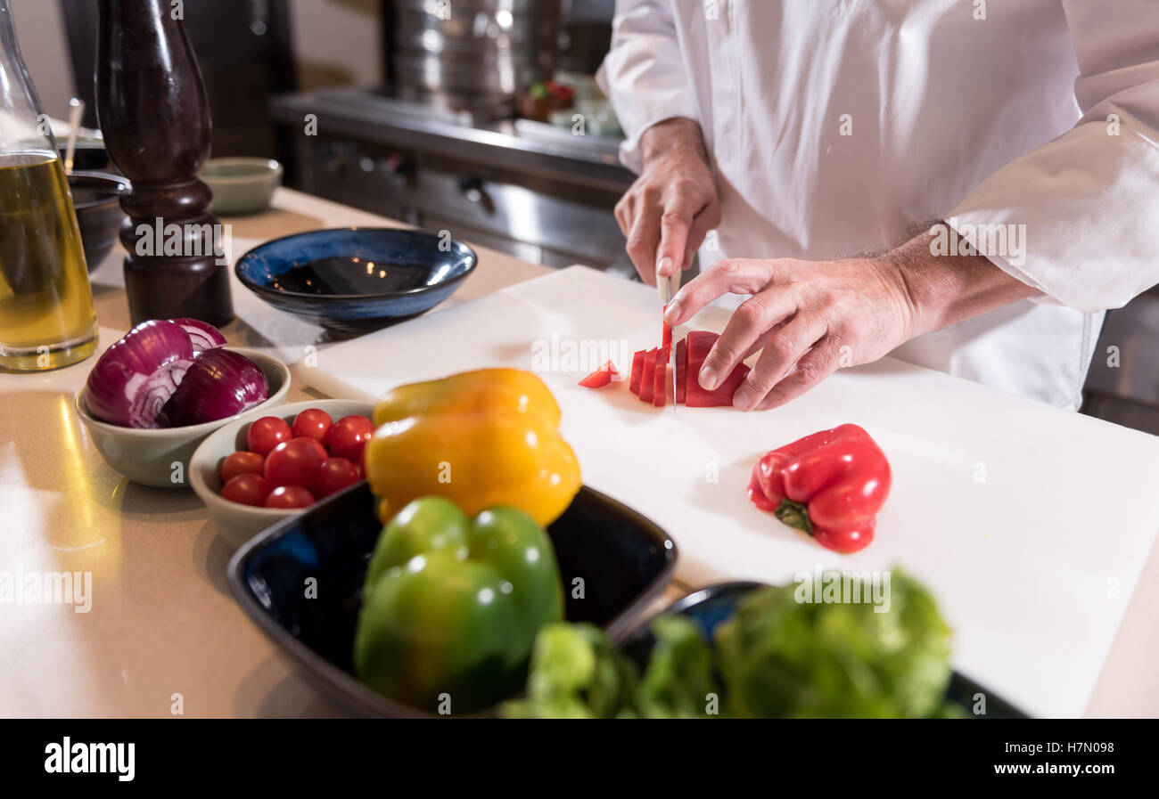 Masculine hands of the chef cutting paper in the kitchen Stock Photo ...