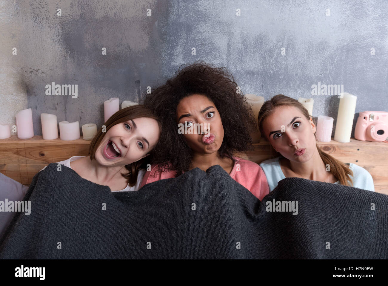 Joyful young girls playing ape in the bedroom at home Stock Photo - Alamy