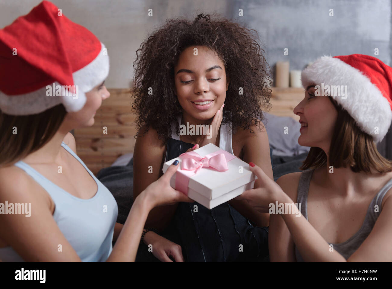 Delighted friends giving presents to each other Stock Photo - Alamy