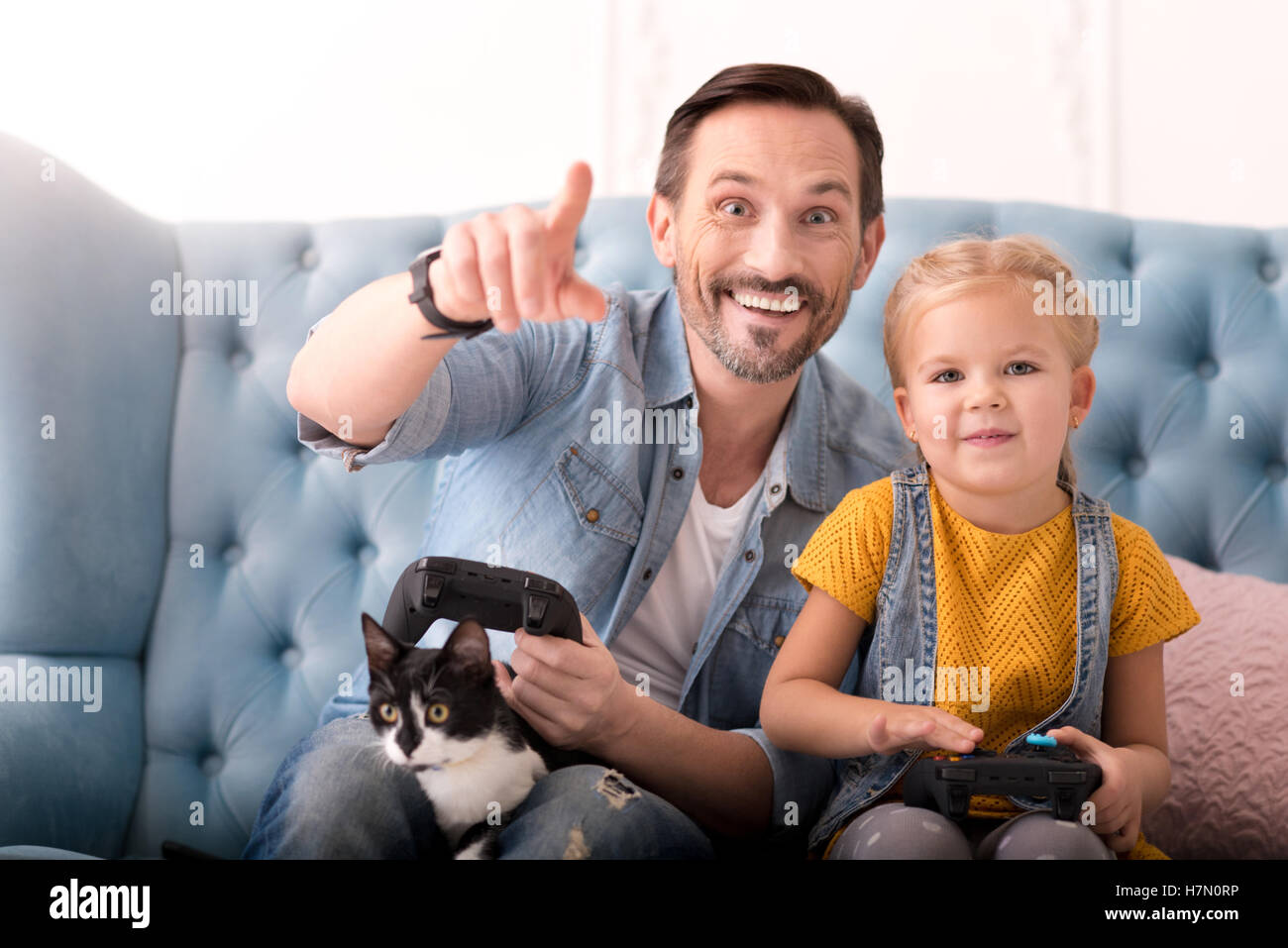 Joyful happy father pointing at something Stock Photo - Alamy