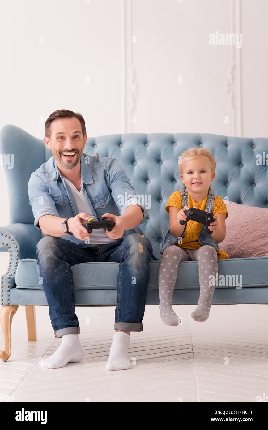 Happy handsome man holding a game console Stock Photo - Alamy