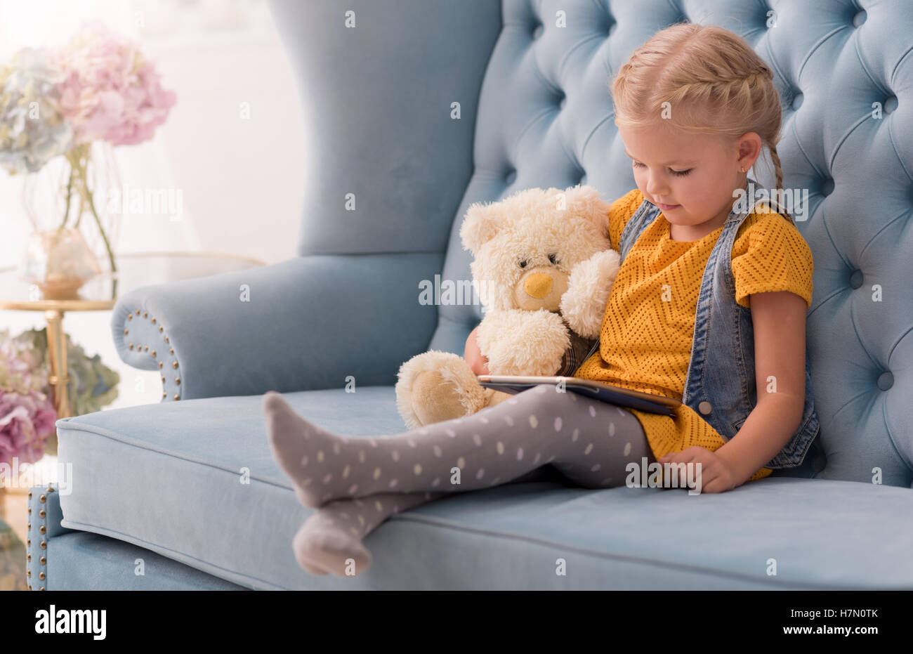 Pretty smart girl reading an electronic book Stock Photo - Alamy