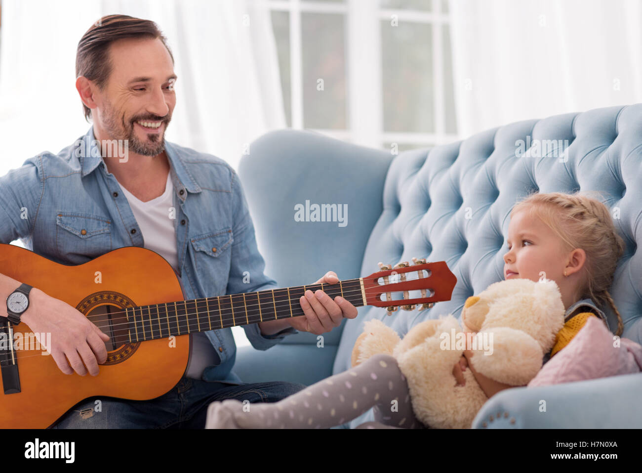 Good looking caring father singing for his daughter Stock Photo - Alamy
