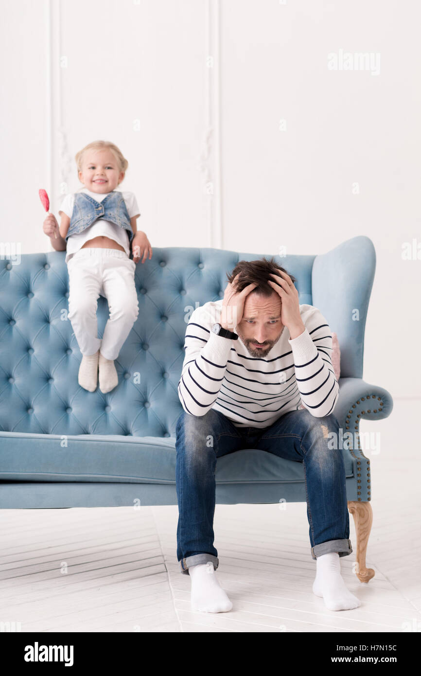 Sad thoughtful father holding his head Stock Photo - Alamy