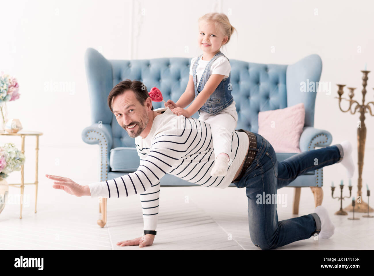 Happy positive father enjoying the time with his daughter Stock Photo ...