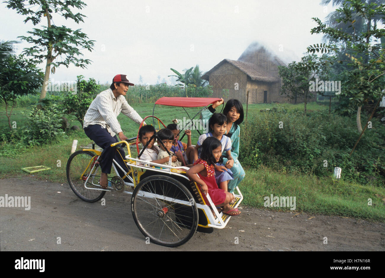 INDONESIA, Java, Forstenlanden, children in cycle rickshaw in village ...