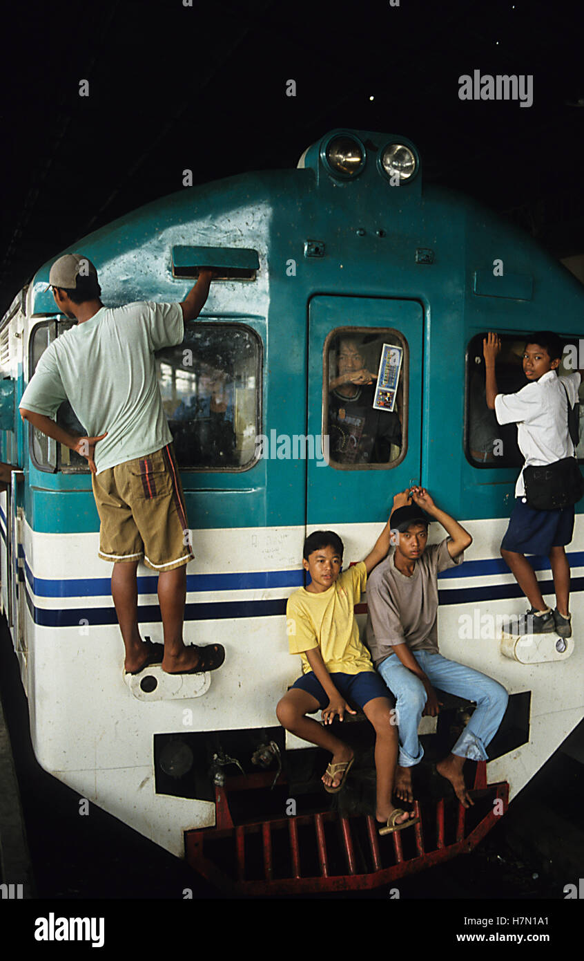 Indonesia Java Jakarta young boys surfing outside at local train in ...