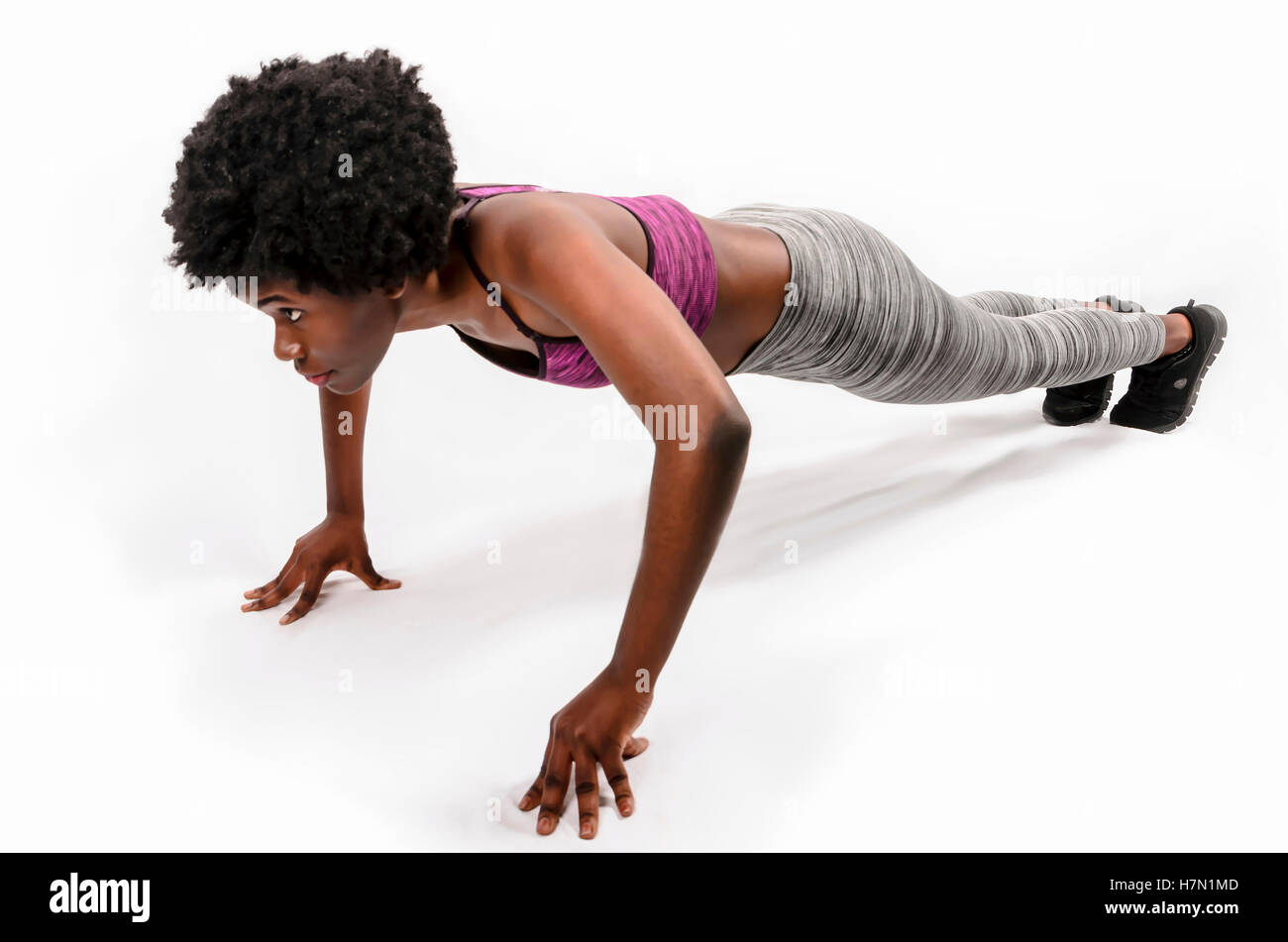 fit black woman doing push-ups over white background Stock Photo - Alamy
