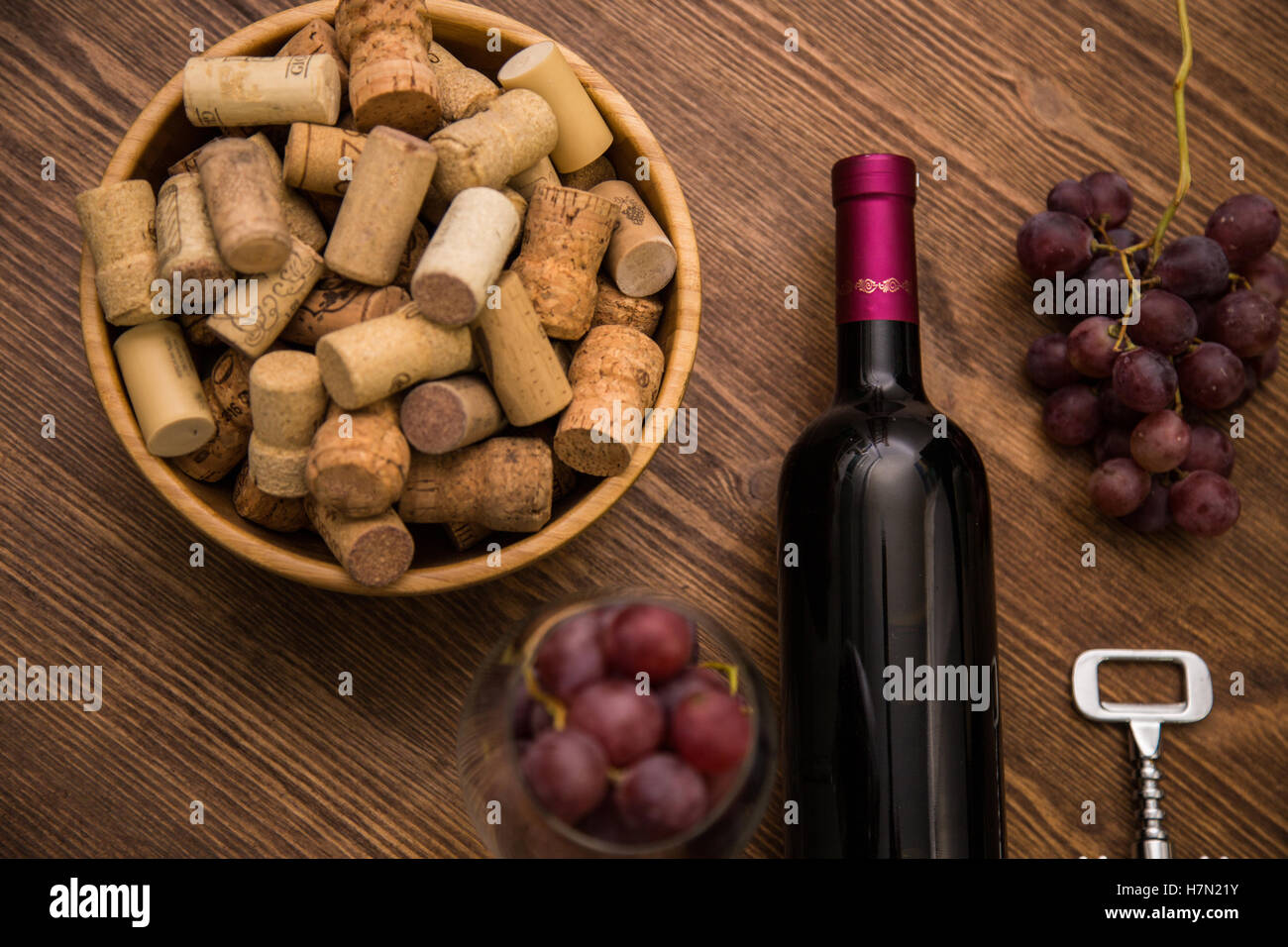 cork stoppers, grape and Wine on wooden table Stock Photo - Alamy
