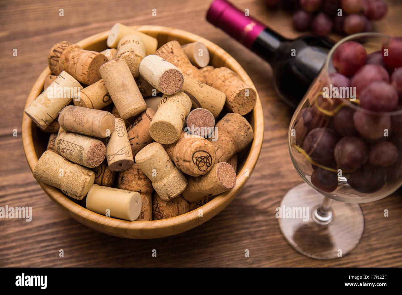 cork stoppers, grape and Wine on wooden table Stock Photo - Alamy