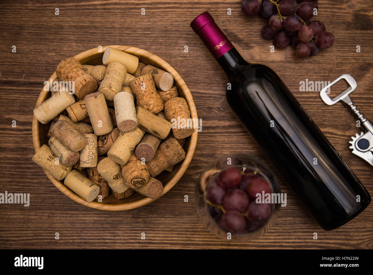 cork stoppers, grape and Wine on wooden table Stock Photo - Alamy