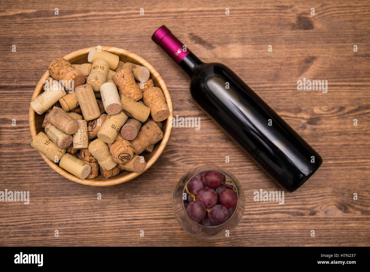 cork stoppers, grape and Wine on wooden table Stock Photo - Alamy