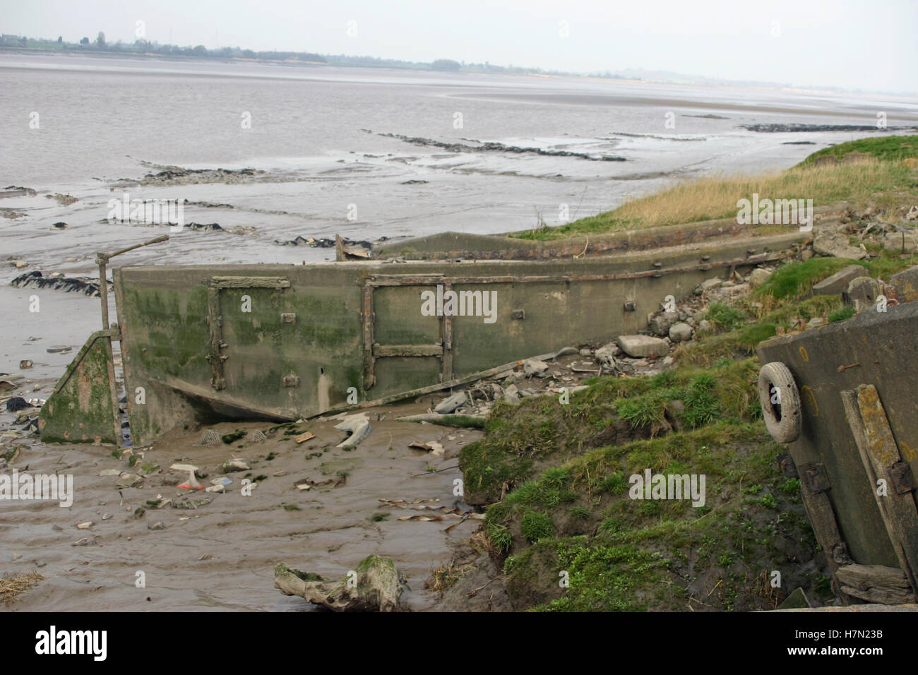 One side (starboard) of a derelict abandoned unusual concrete barge ...