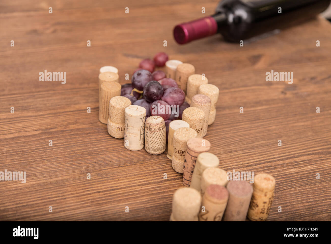 cork stoppers, grape and Wine on wooden table Stock Photo - Alamy