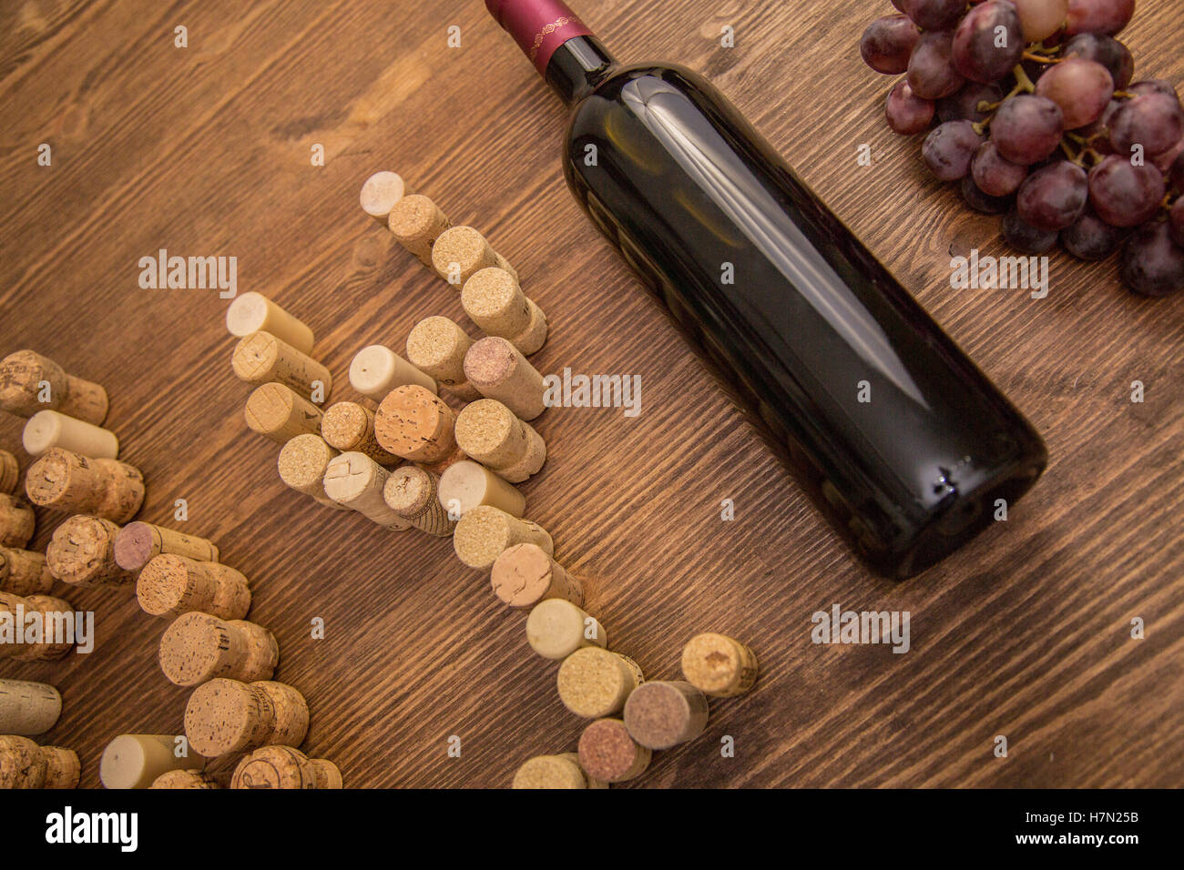 cork stoppers, grape and Wine on wooden table Stock Photo - Alamy