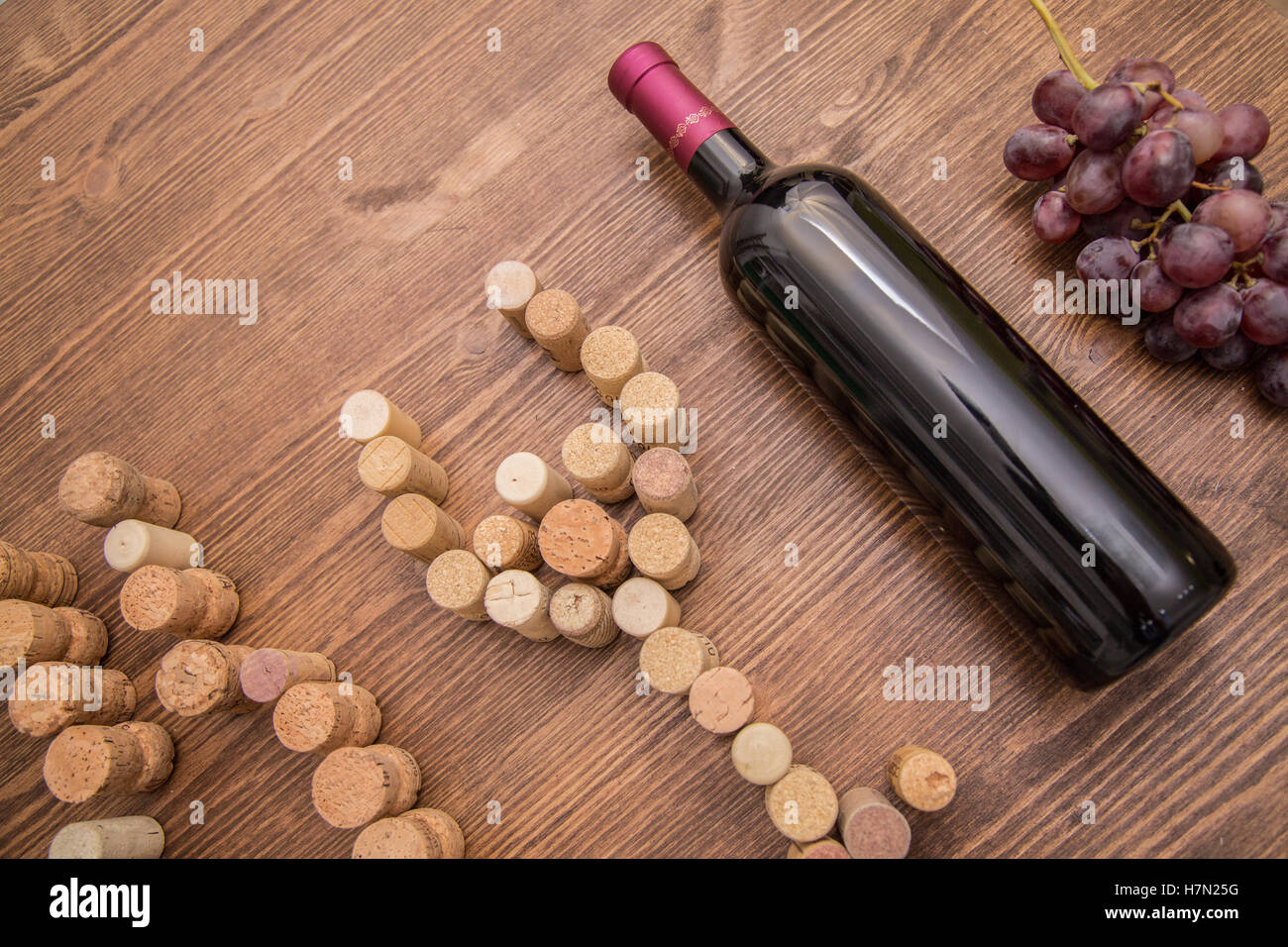 cork stoppers, grape and Wine on wooden table Stock Photo - Alamy