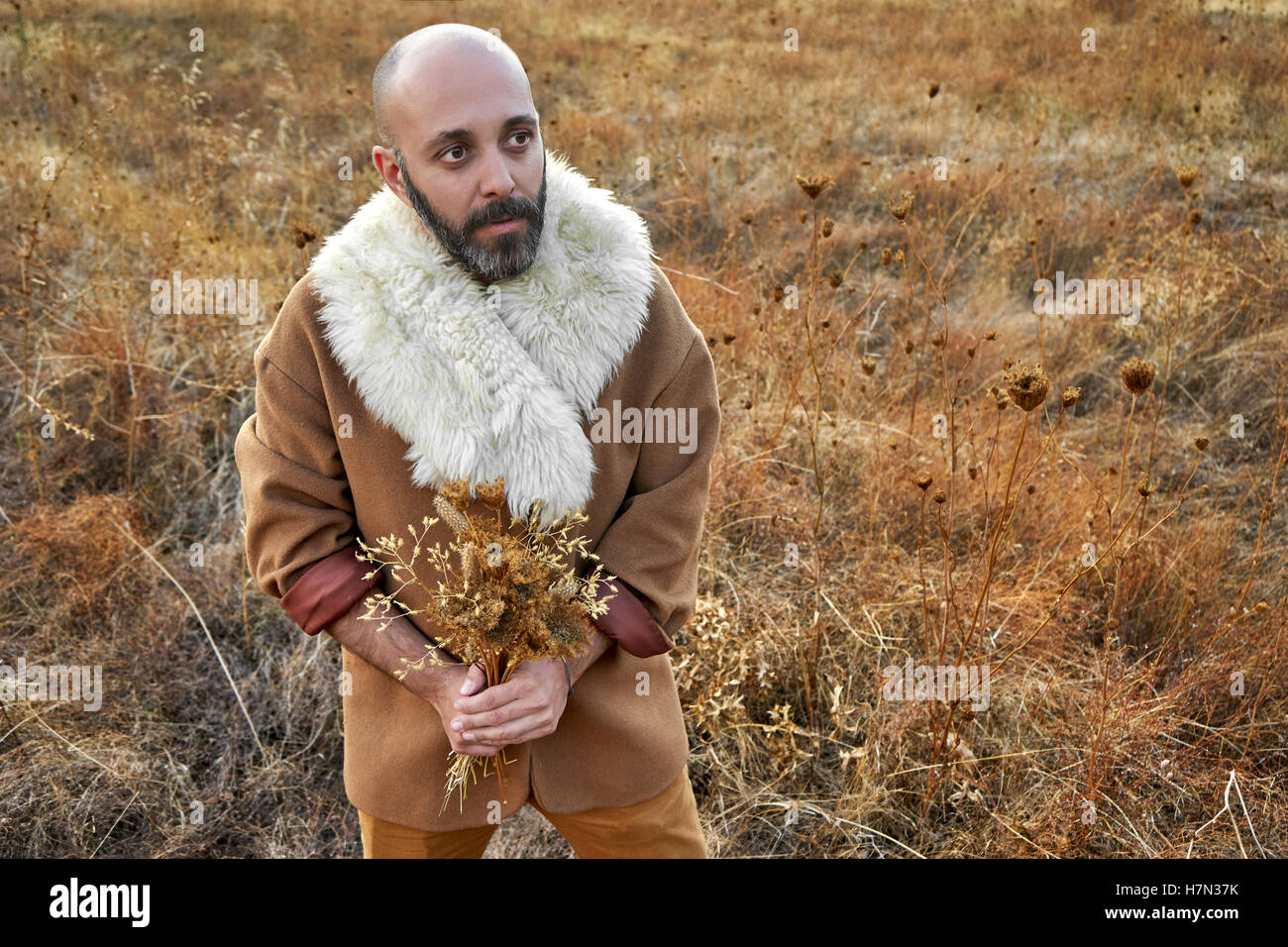 Vintage concept with a man holding a bouquet of dry flowers Stock Photo ...