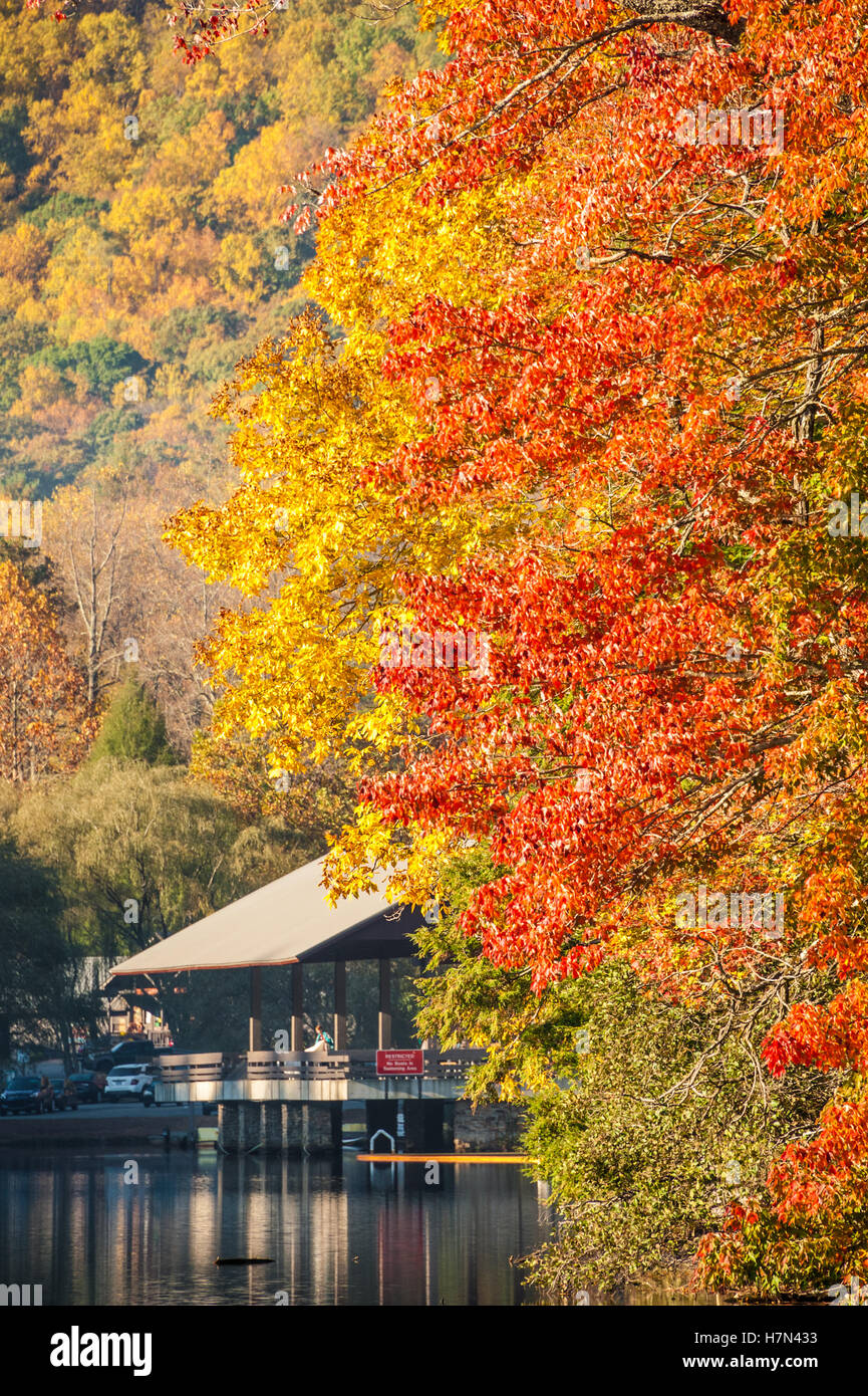Colors of Autumn paint the mountainside above the lakefront pavilion at ...