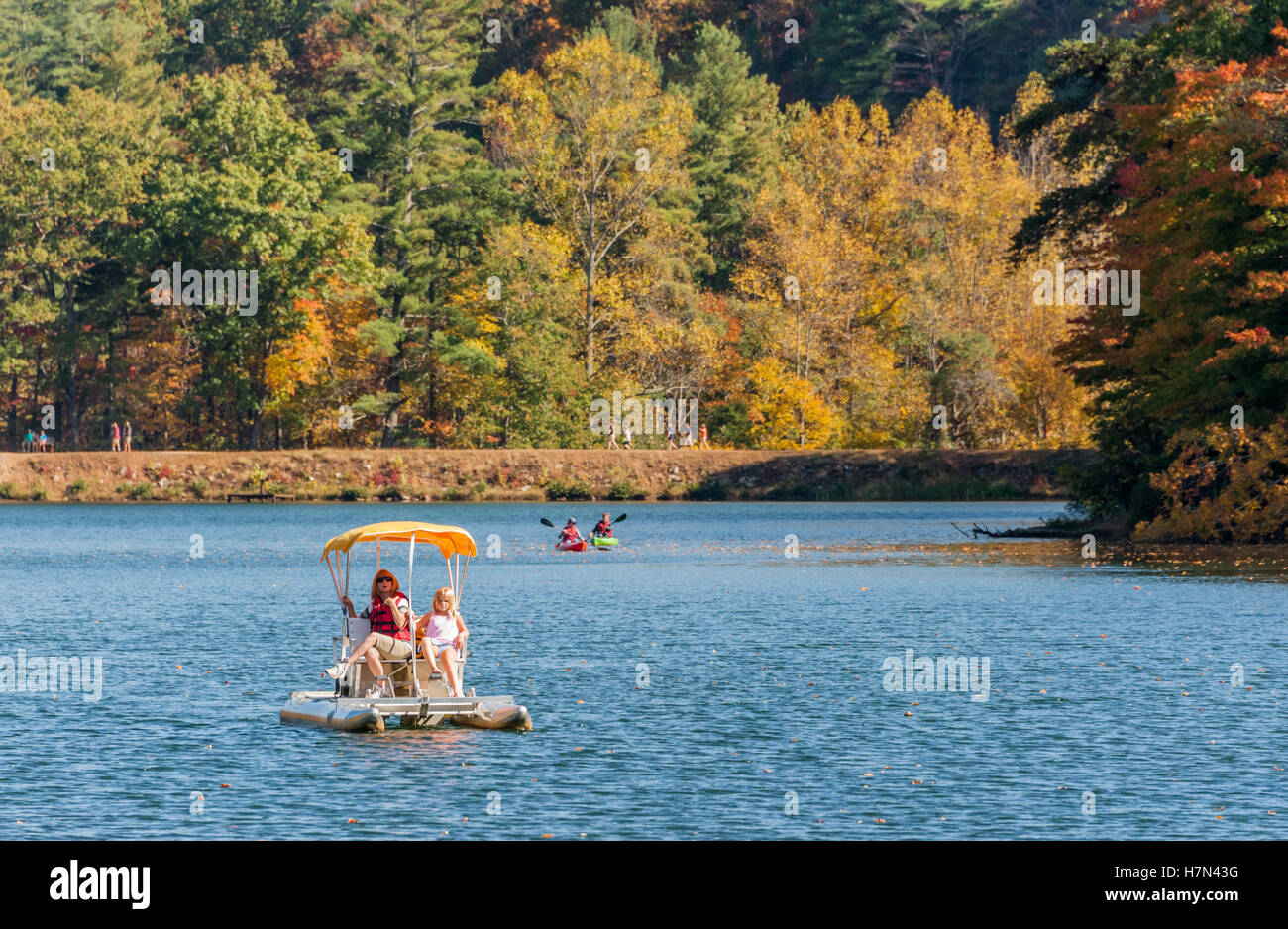 Families enjoying the walking trail and boating activities at Lake ...