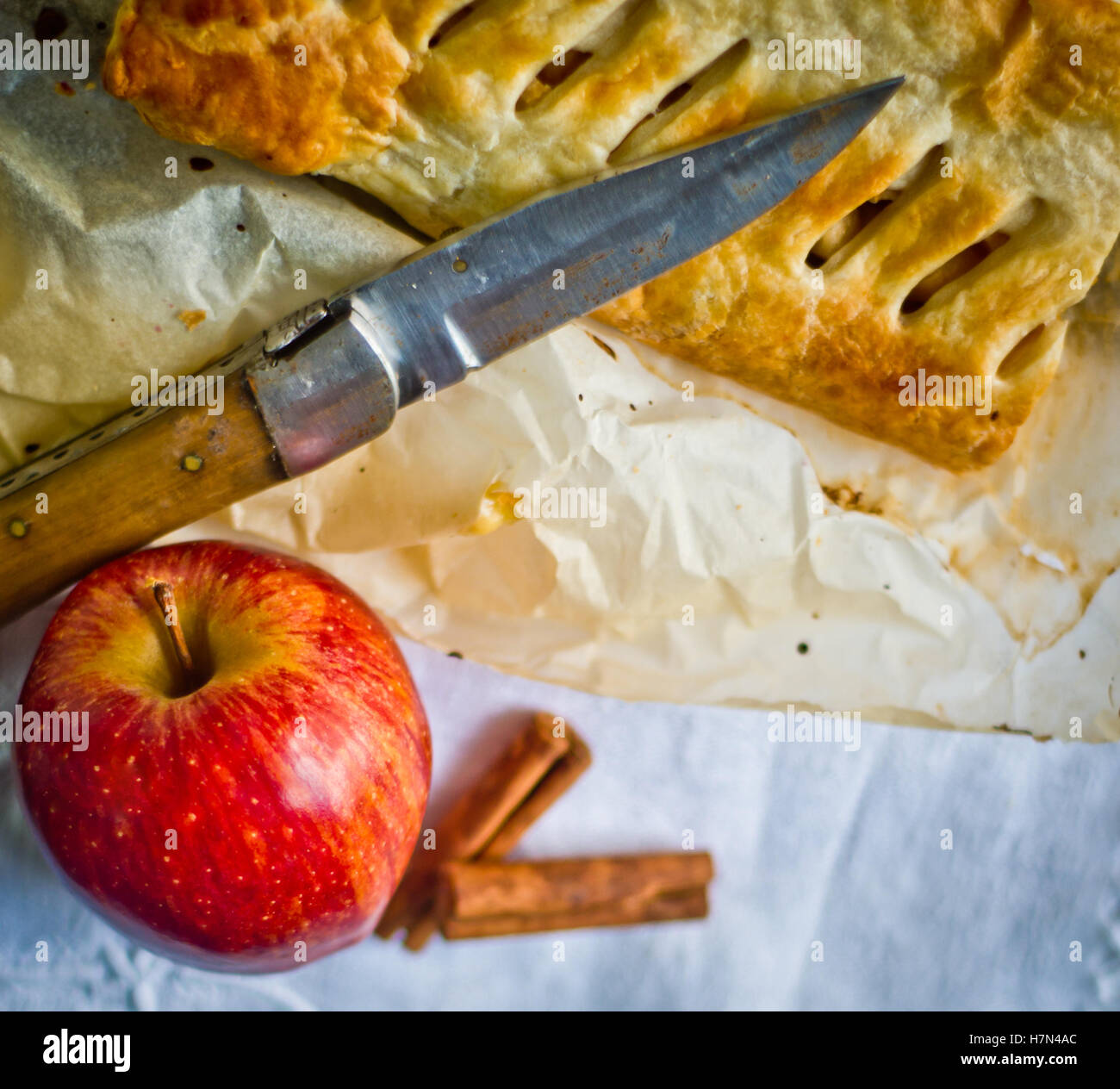 stredel homemade pie with apples and cinnamon, cut with a knife lying ...