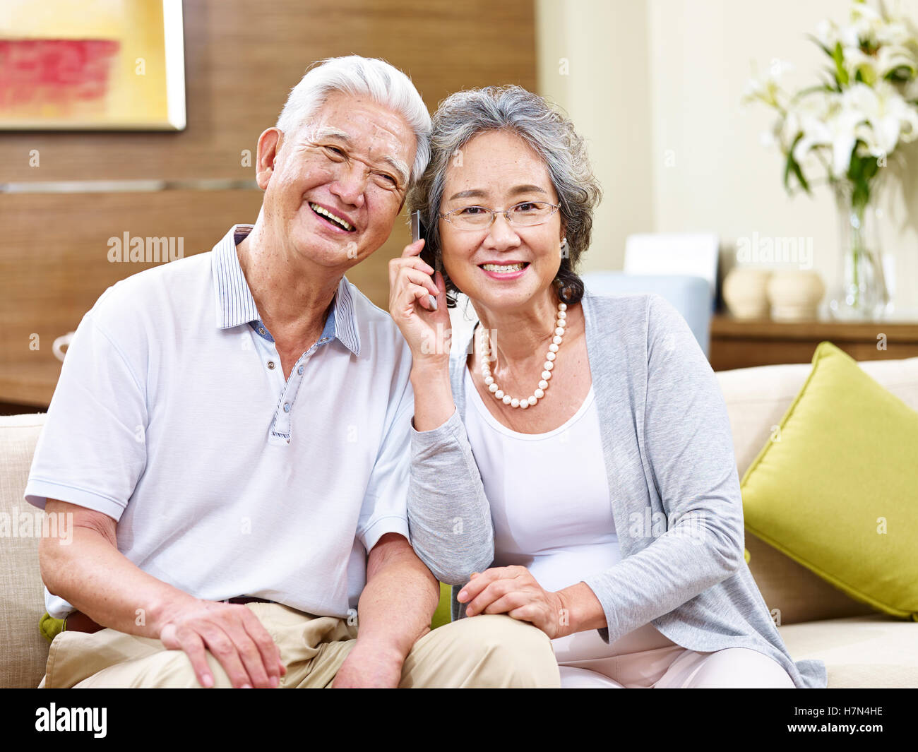 senior asian couple calling their children using mobile phone Stock ...