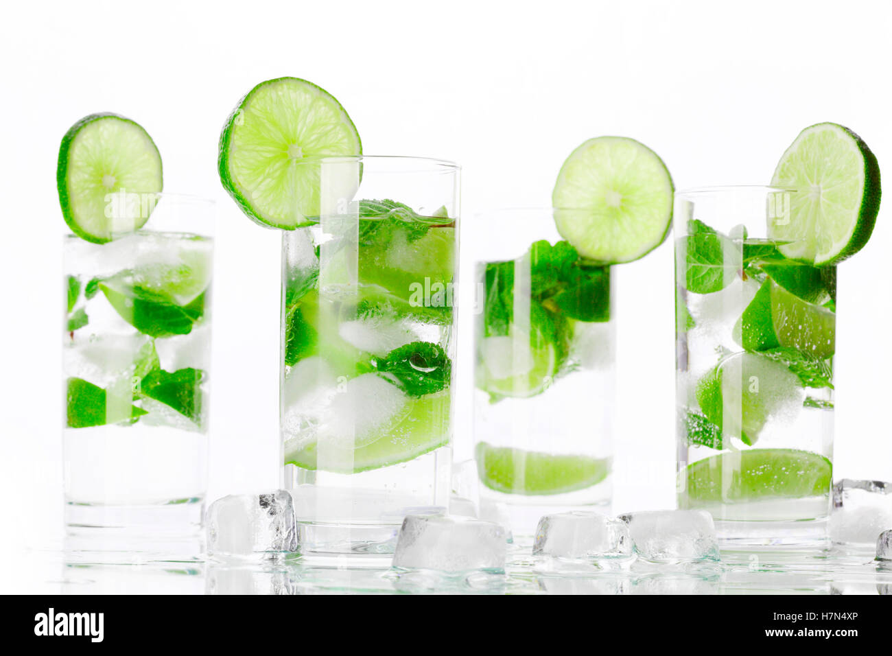 Party mojito cocktails with lime and mint isolated on white background ...