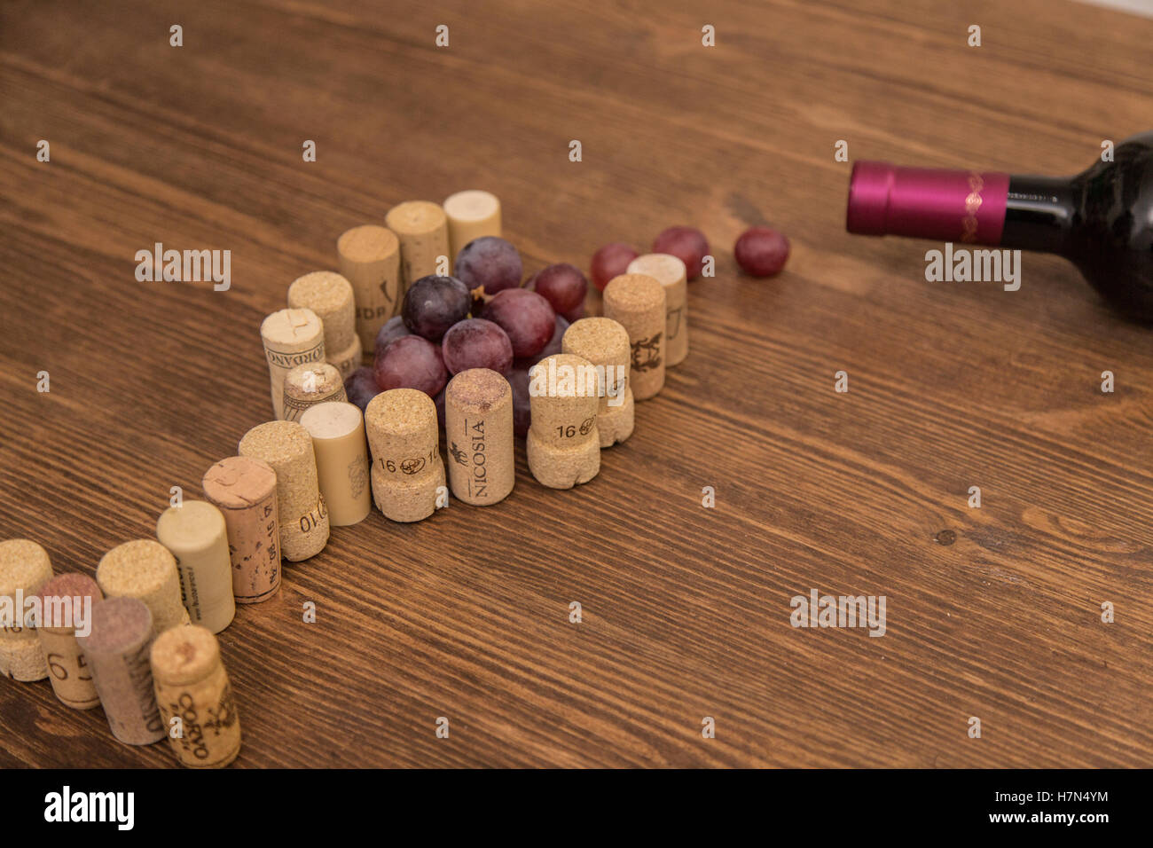 cork stoppers, grape and Wine on wooden table Stock Photo - Alamy