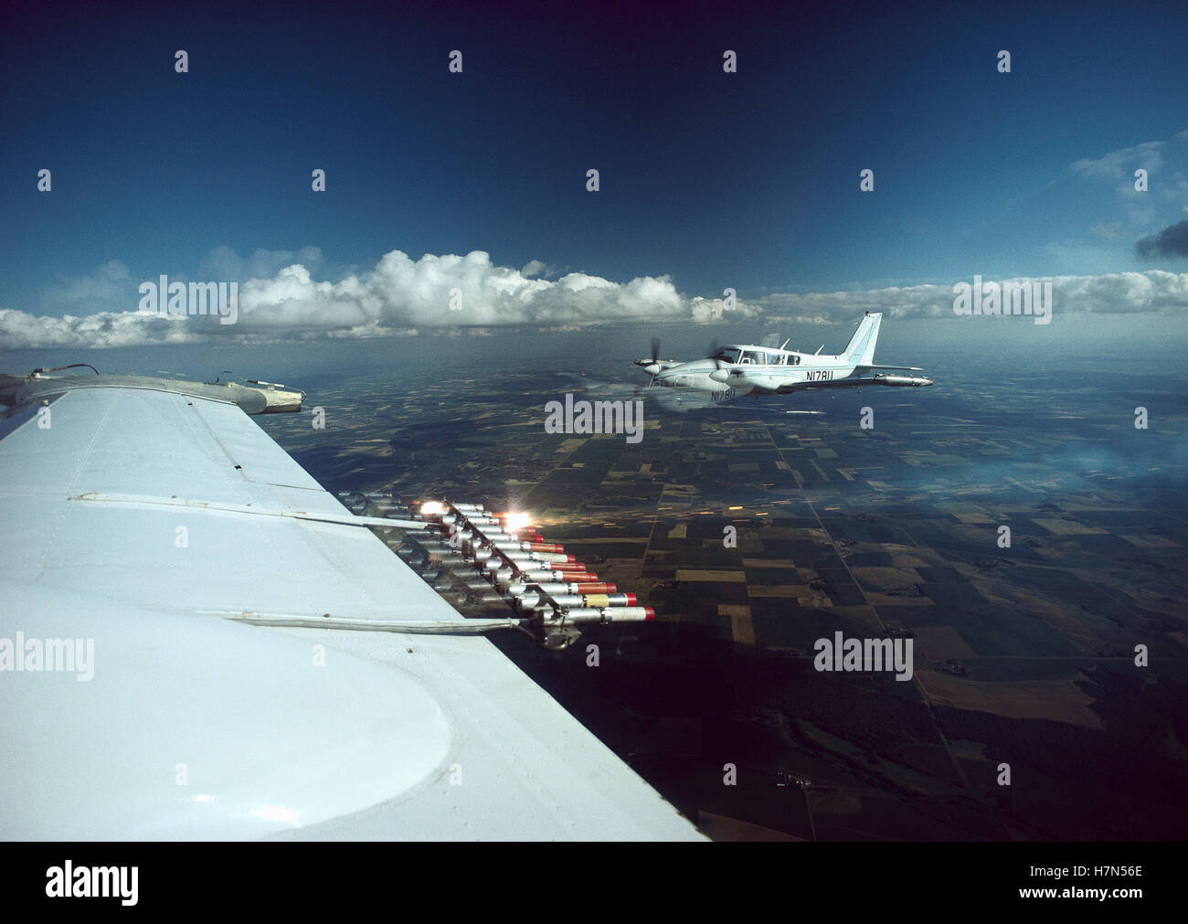 Cloud seeding equipment on wing of plane viewed through window flying ...